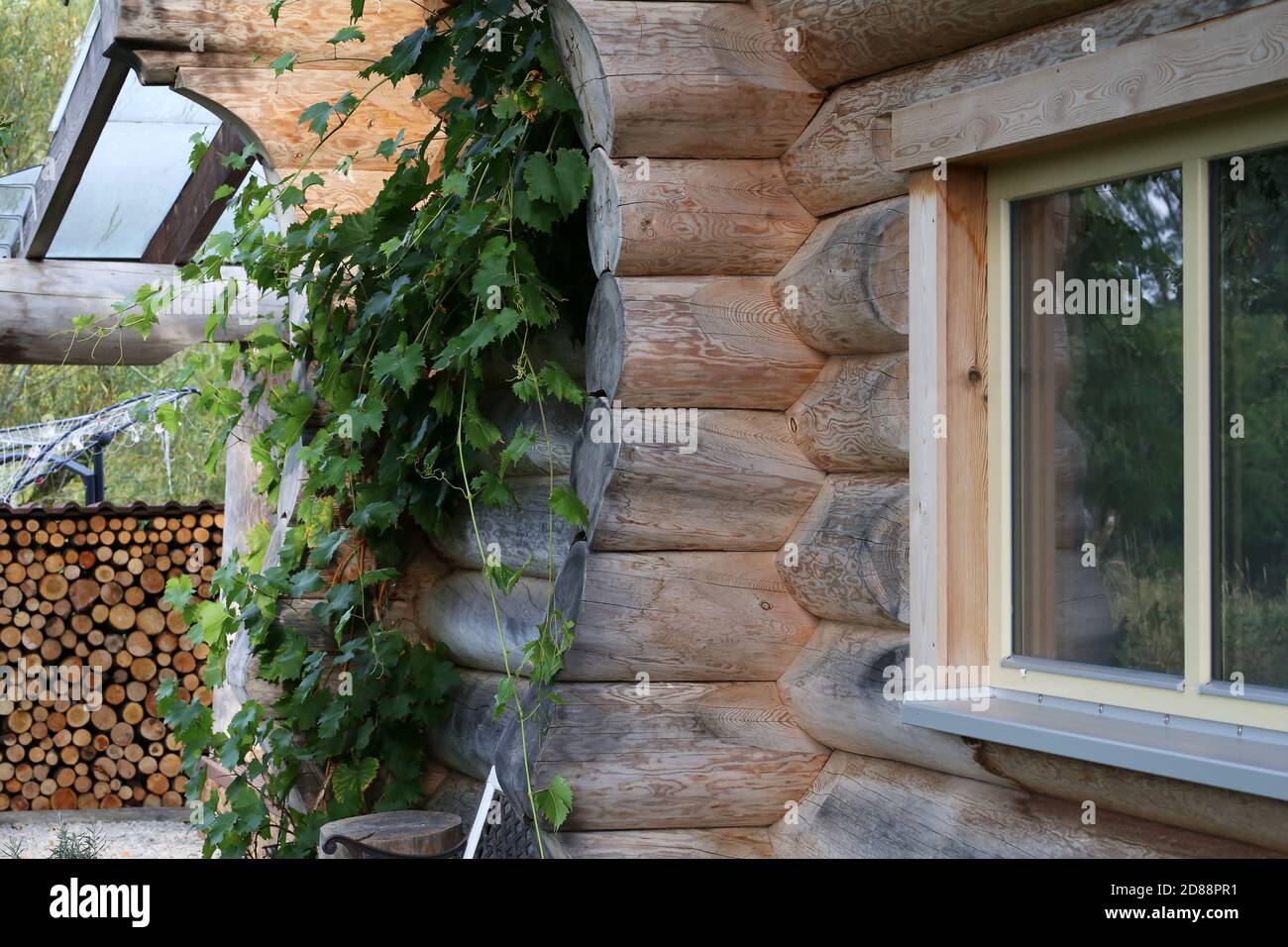 Wooden hut made of round planed logs Stock Photo - Alamy