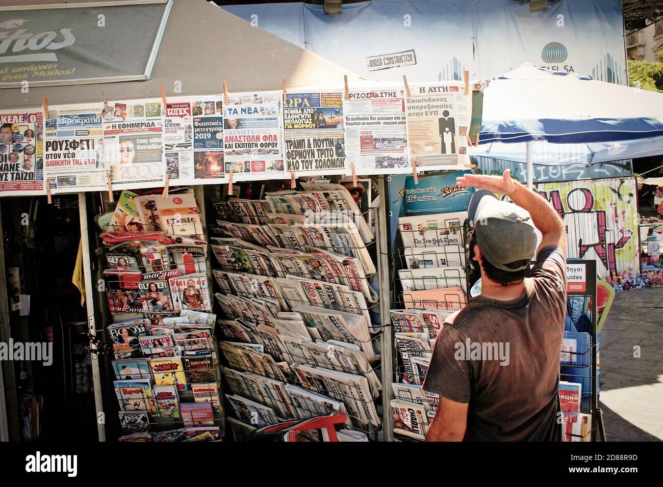 Man looking at newspapers at a press kiosk in Athens, Greece, August 31 ...
