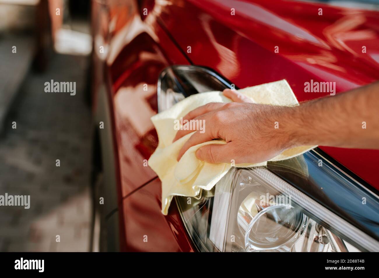 Man cleaning the car with yellow microfiber mop Stock Photo - Alamy