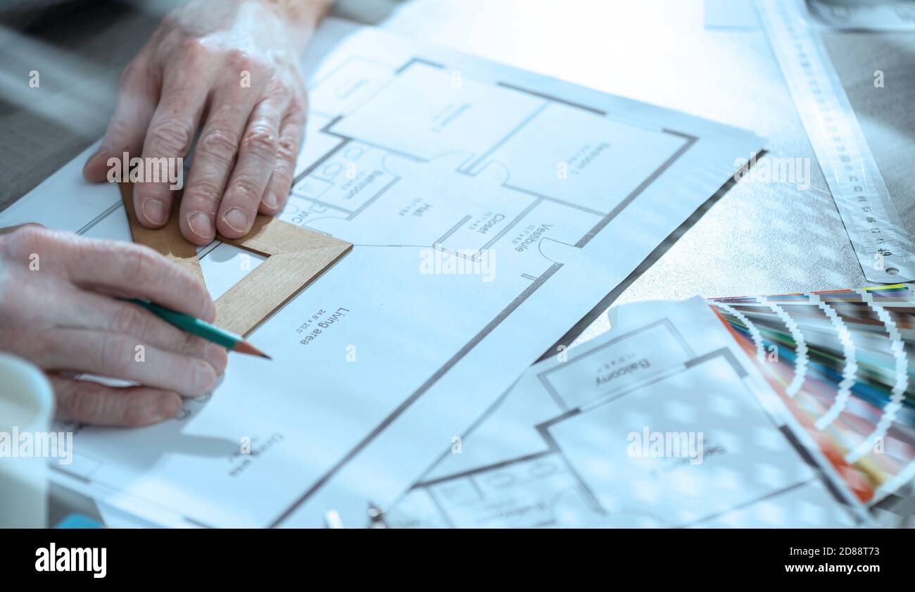 Architect working on a project and using a square; light effect Stock ...