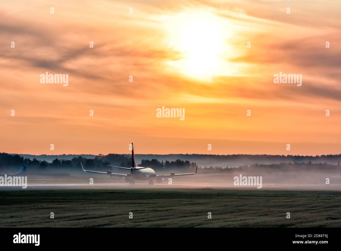 Picturesque dawn with a fog at the airport. Passenger aircraft on the ...