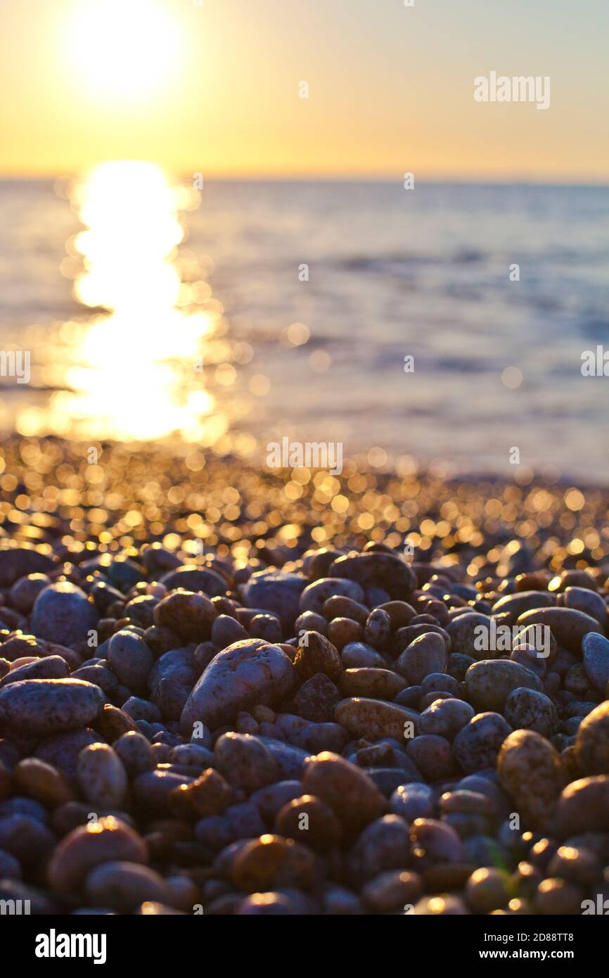 Beautiful seascape, amazing view of pebble coastline in mild sunset ...