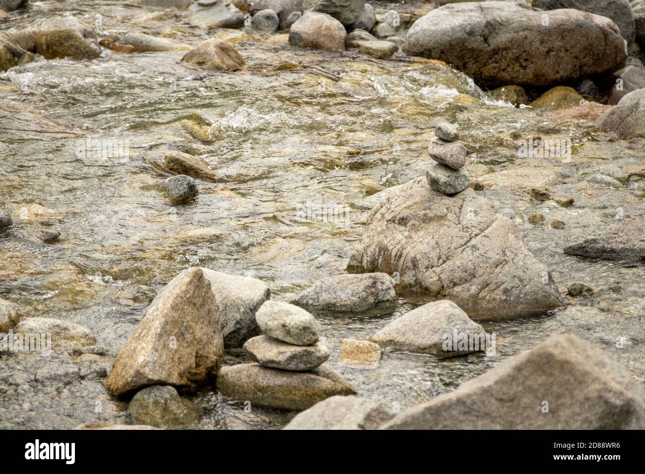 Stones stacked on top of each other in the river Stock Photo - Alamy