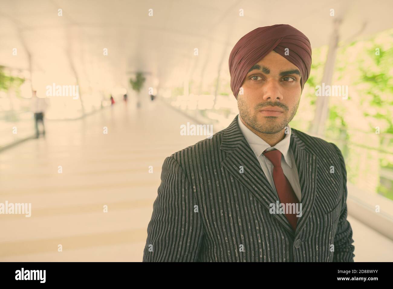 Young handsome Indian Sikh businessman wearing turban while exploring ...