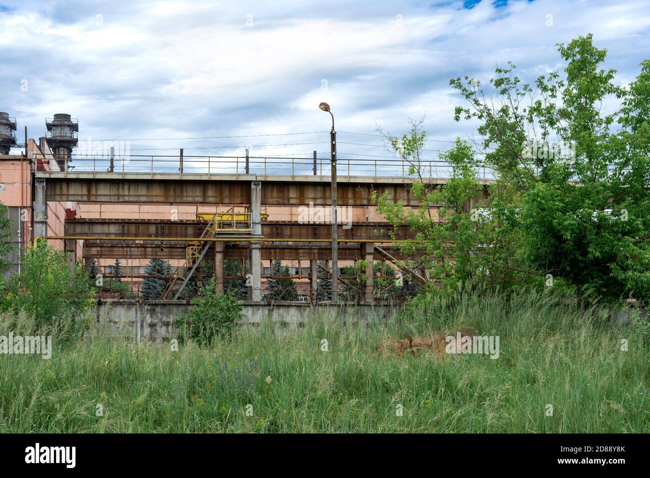 old dilapidated factory overgrown with green grass Stock Photo - Alamy