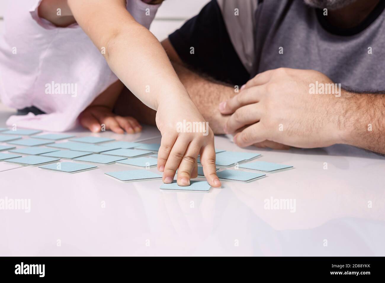dad and little daughter play together. Memo cards for early childhood ...