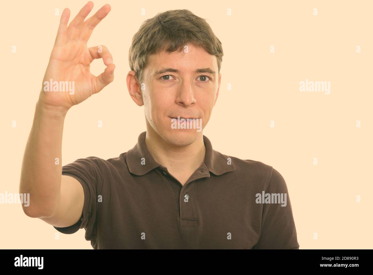 Studio shot of man giving ok sign Stock Photo - Alamy
