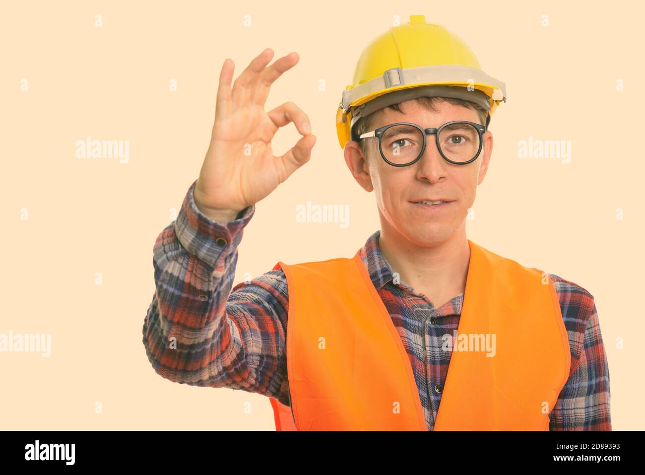 Studio shot of man construction worker giving ok sign Stock Photo - Alamy