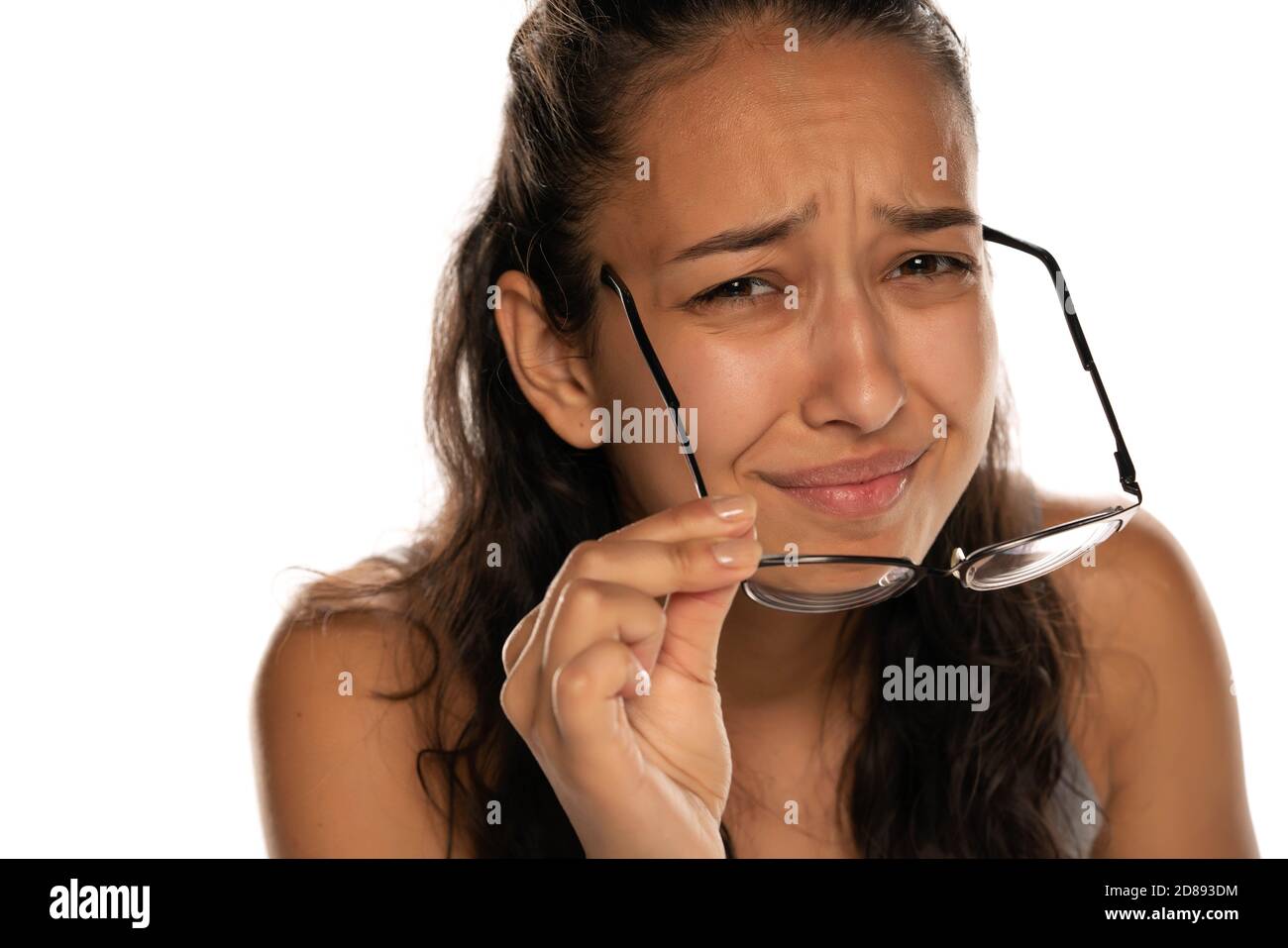 Portrait of dark skinned woman with bad sight on white background Stock ...