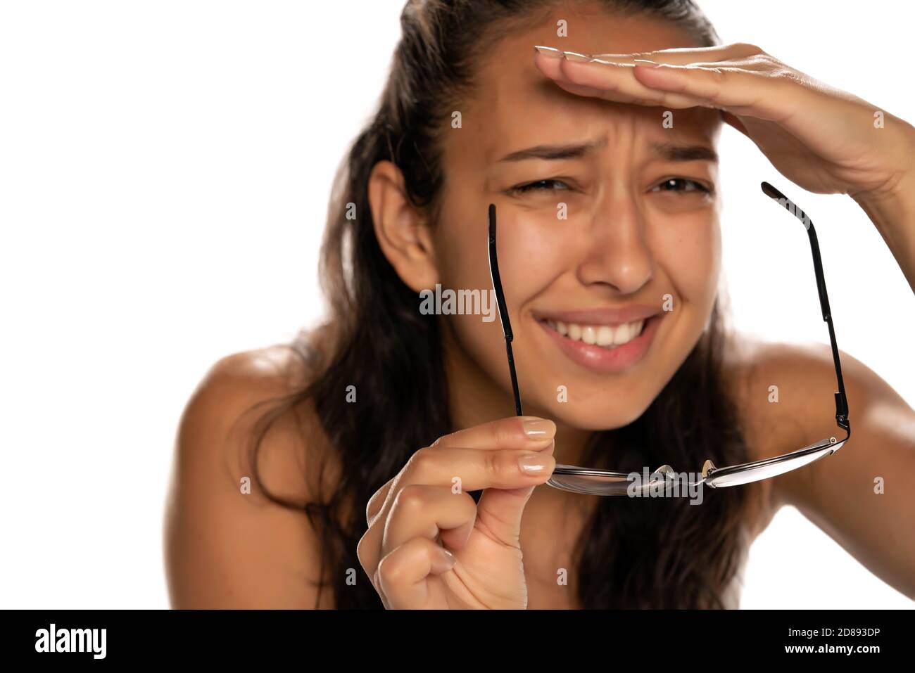 Portrait of dark skinned woman with bad sight on white background Stock ...