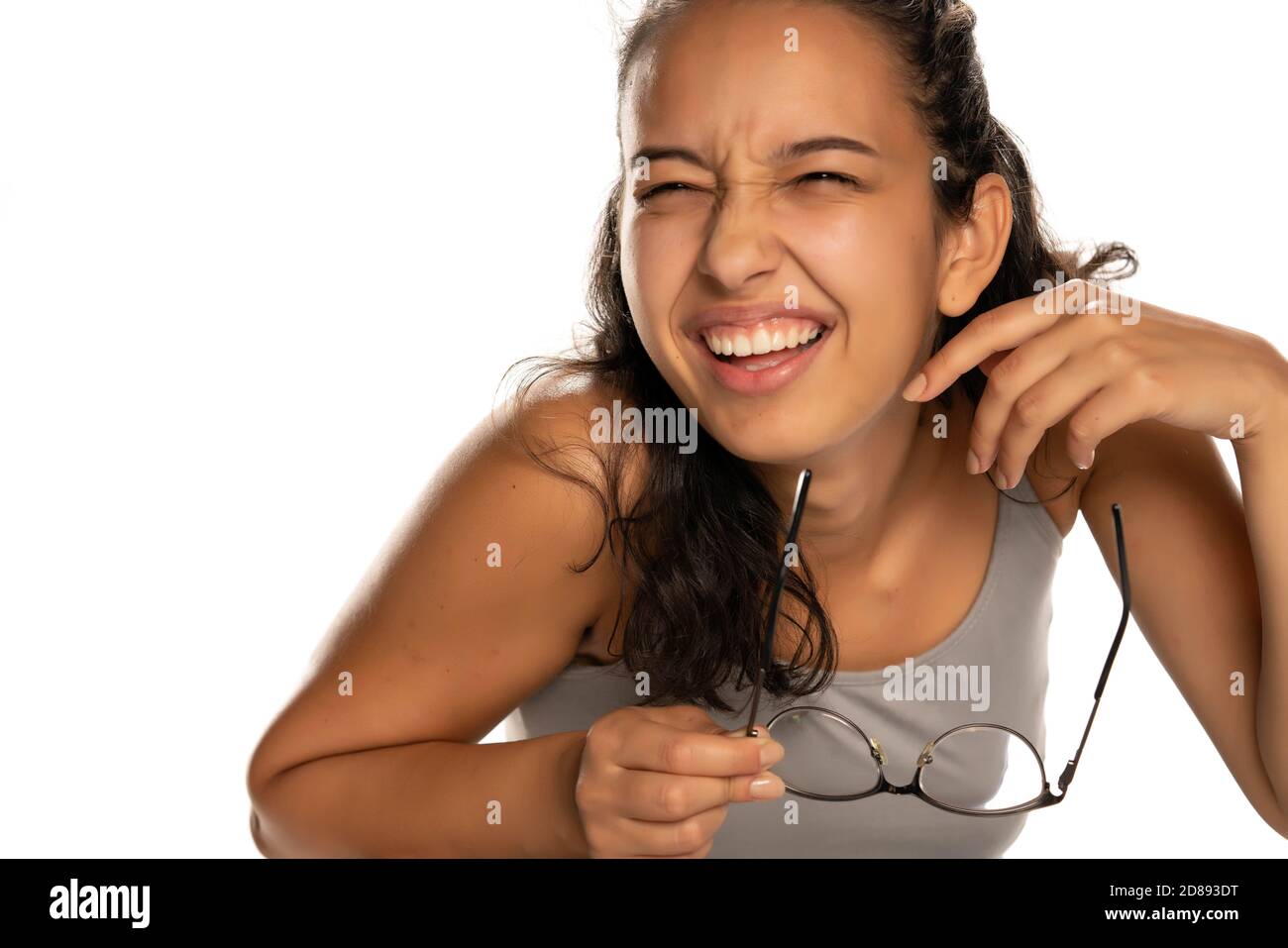 Portrait of dark skinned woman with bad sight on white background Stock ...