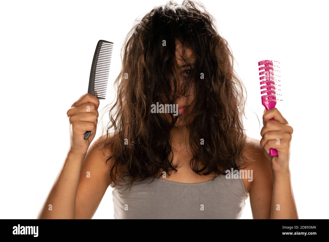 Young unknown woman with messy hair on white background Stock Photo - Alamy