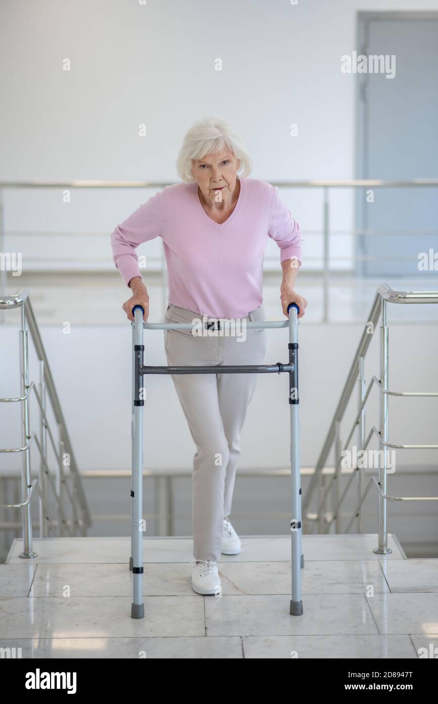 Elderly woman walker stairs hi-res stock photography and images - Alamy