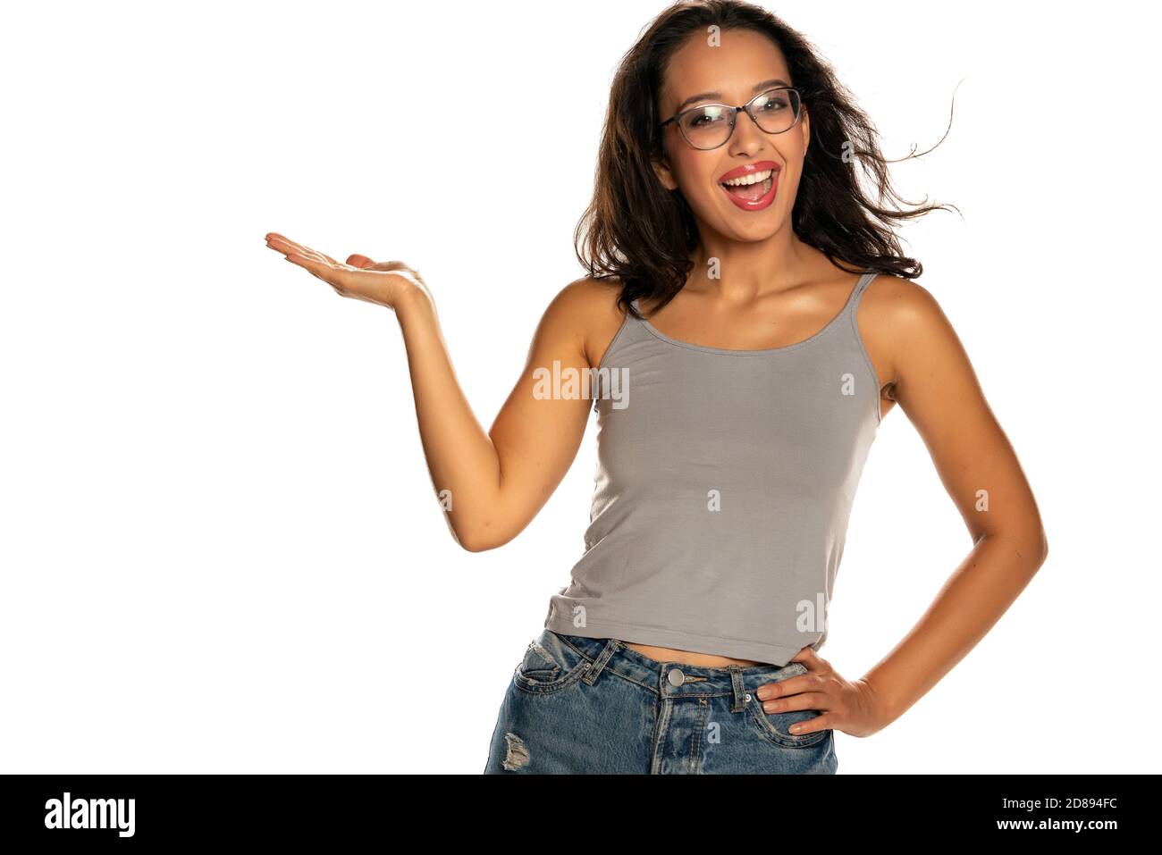 Happy dark skinned woman holding imaginary object on white background ...