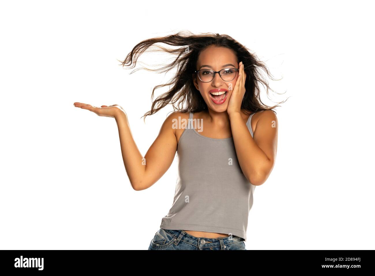 Happy dark skinned woman holding imaginary object on white background ...