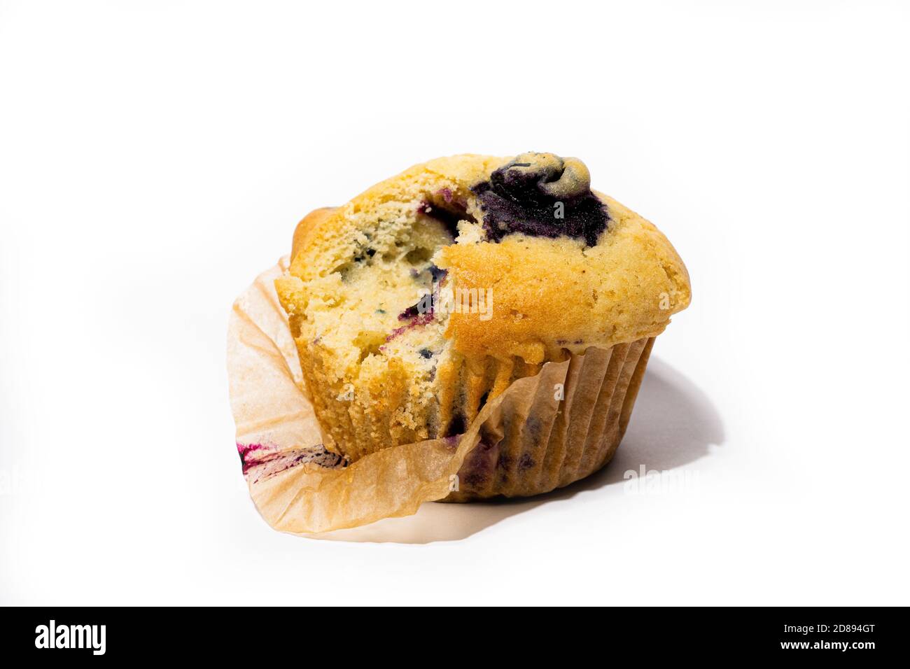 Bitten cupcake on white surface Stock Photo - Alamy