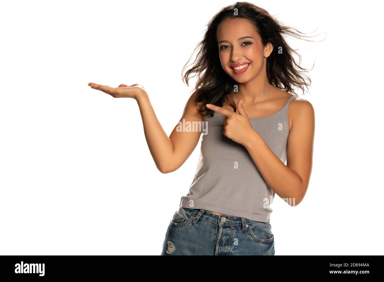 Happy dark skinned woman holding imaginary object on white background ...