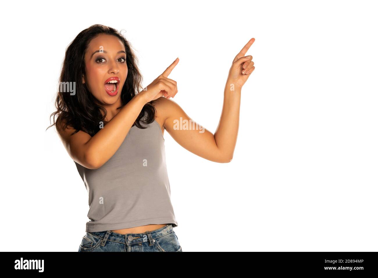 Happy dark skinned woman pointing on white background Stock Photo - Alamy