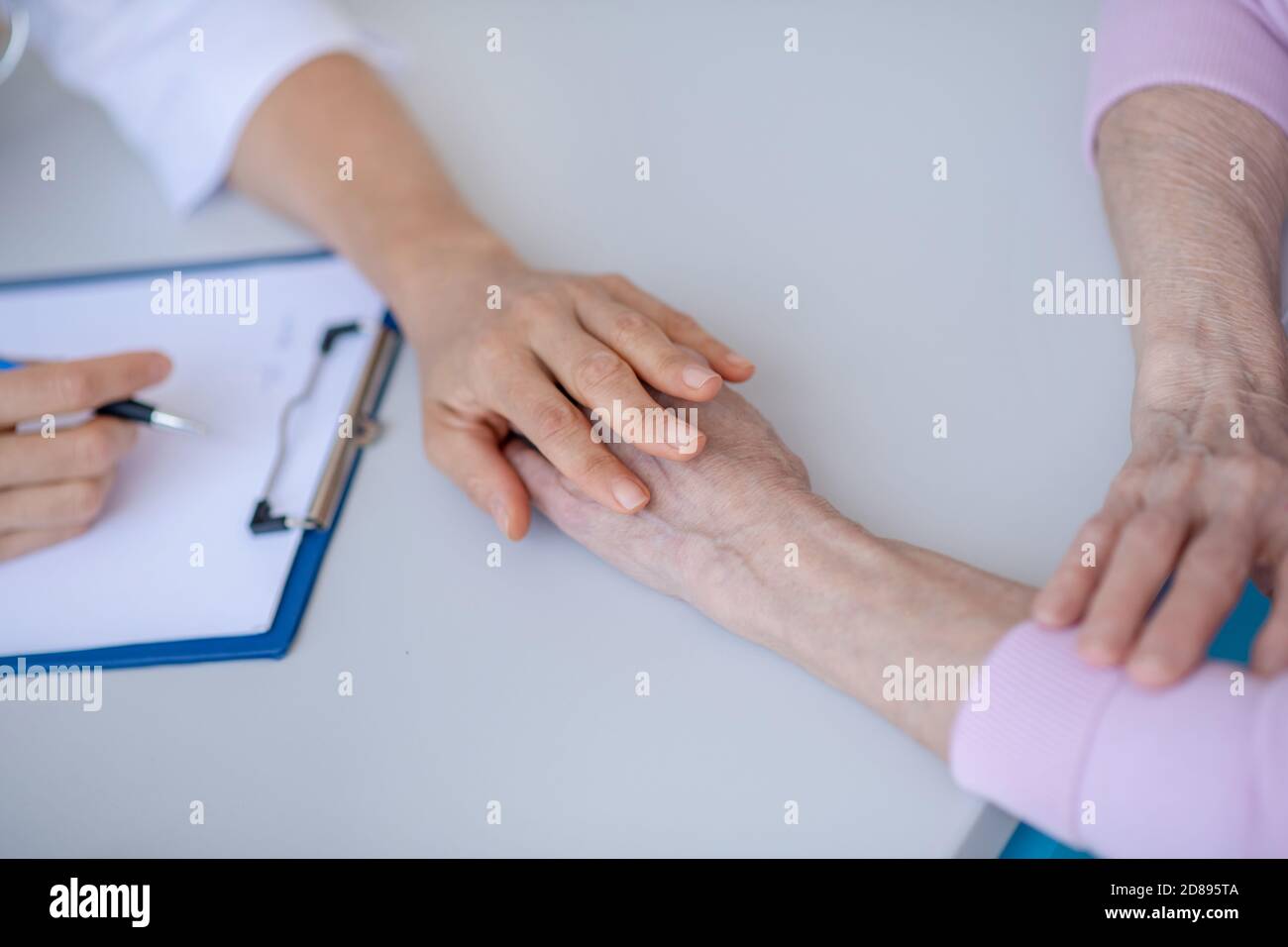 Close up picture of human hands on the table Stock Photo - Alamy