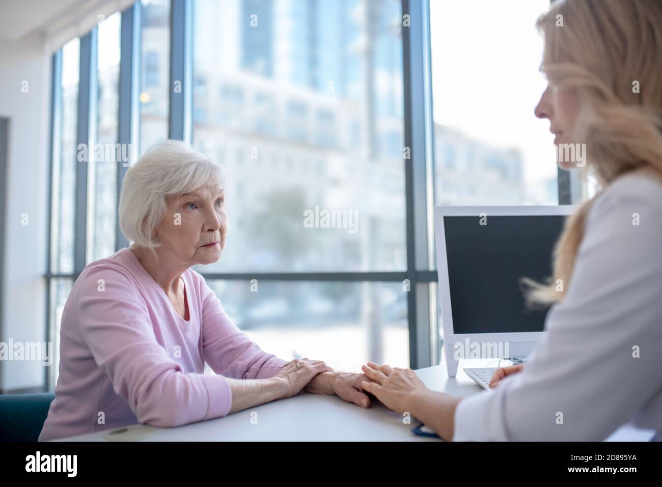 Doctor putting her hand on patients hand showing support Stock Photo ...