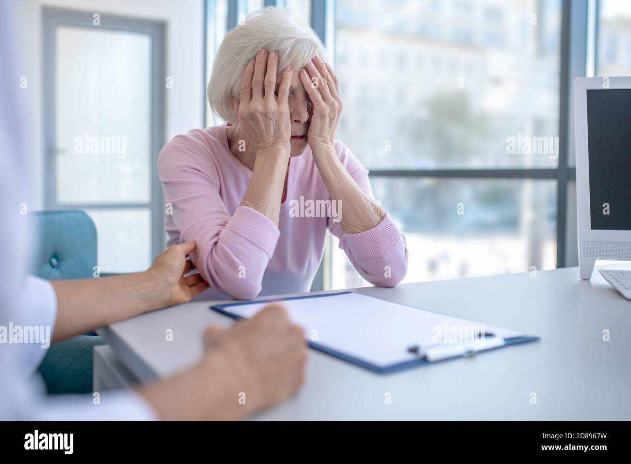 Elderly patient feeling desperate after reading the test results Stock ...