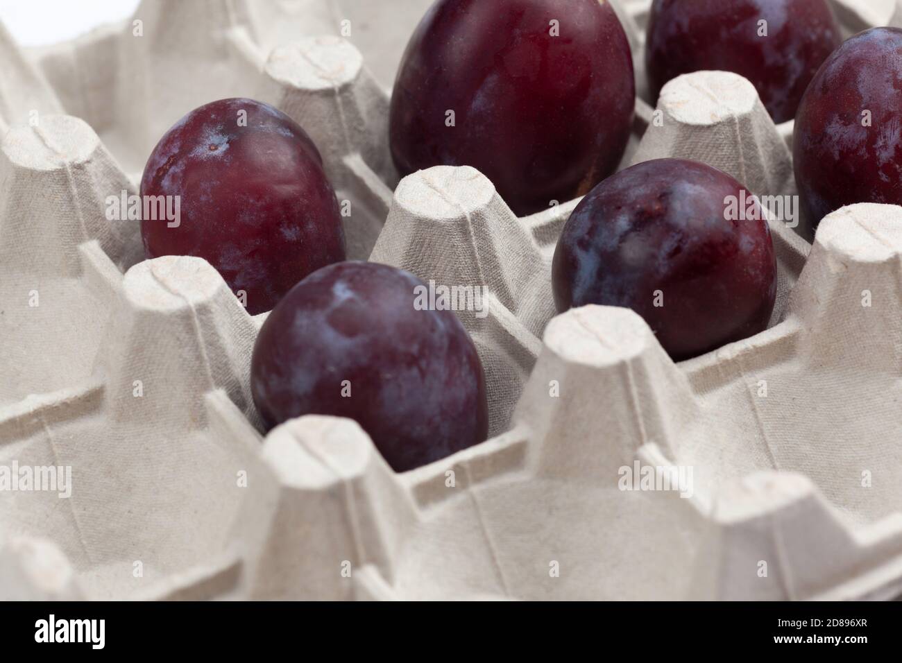 six purple plums Stock Photo - Alamy