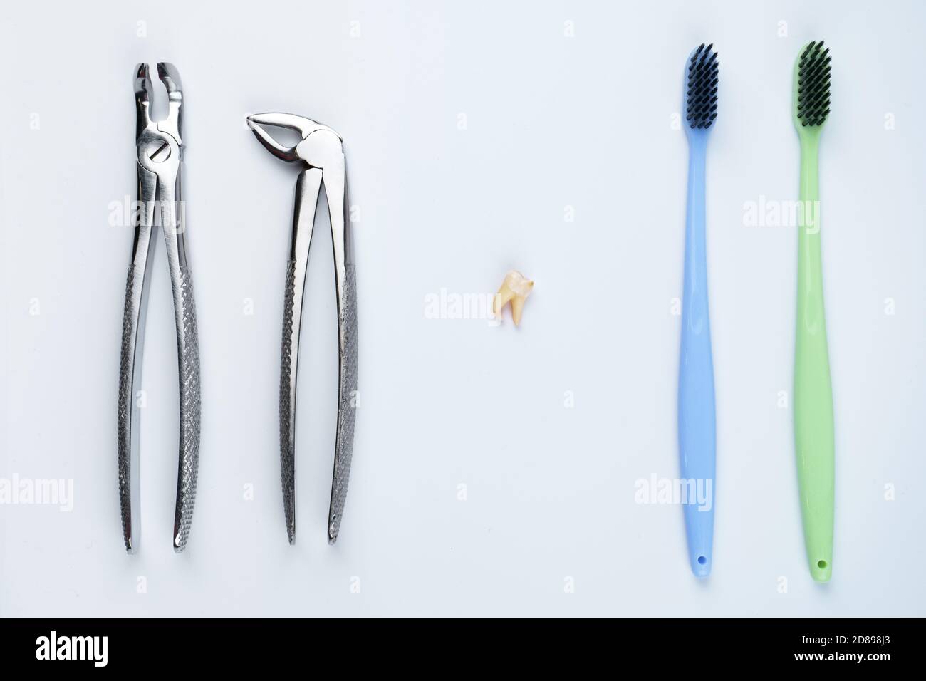 Photo of two dental tools with tooth on isolated white background Stock ...