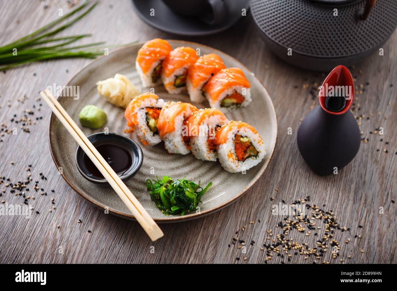 Sushi maki rolls with salmon, avocado, flying fish roe and cucumber on ...