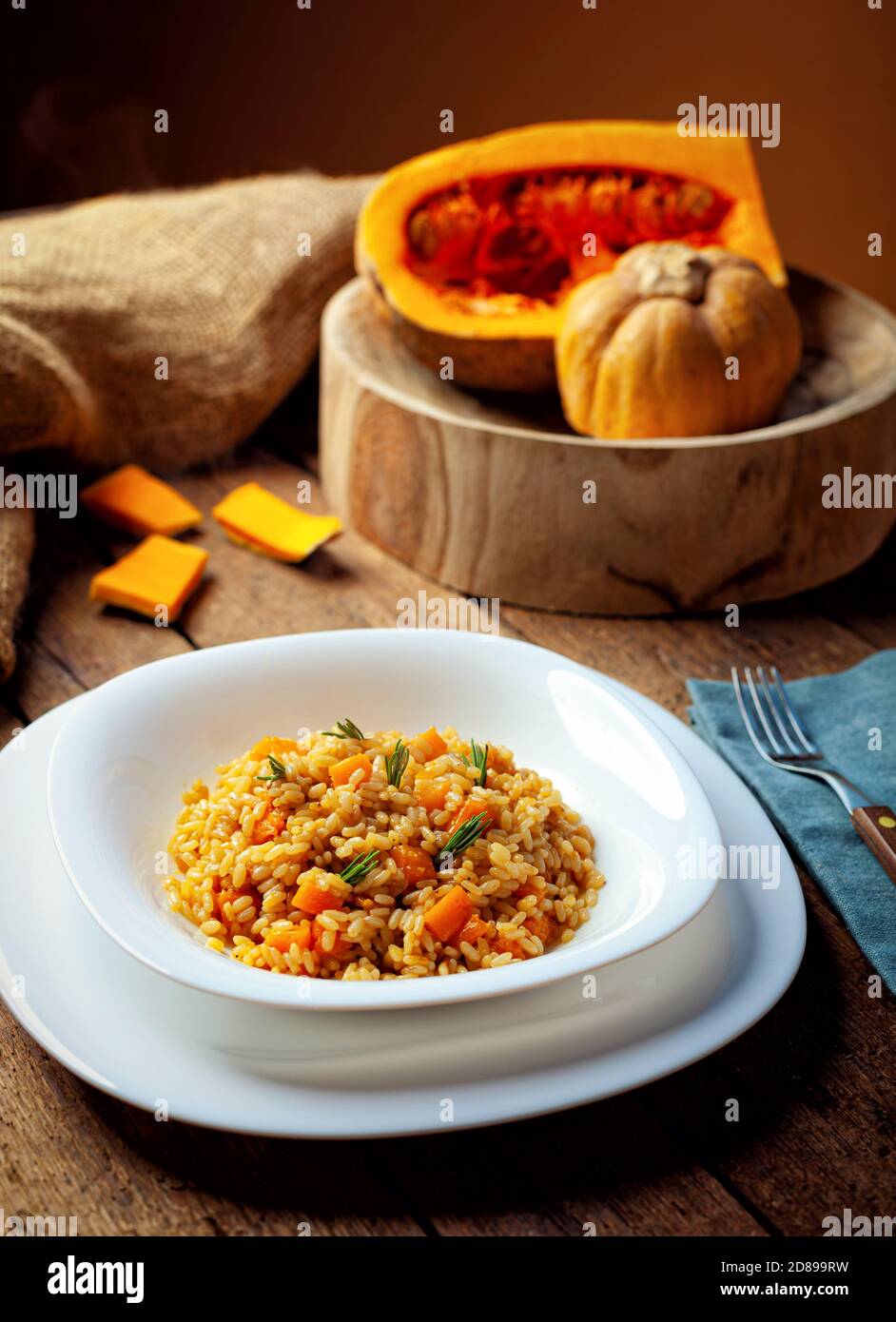 Pumpkin risotto, recipe with rice and pumpkin on rustic table with ...