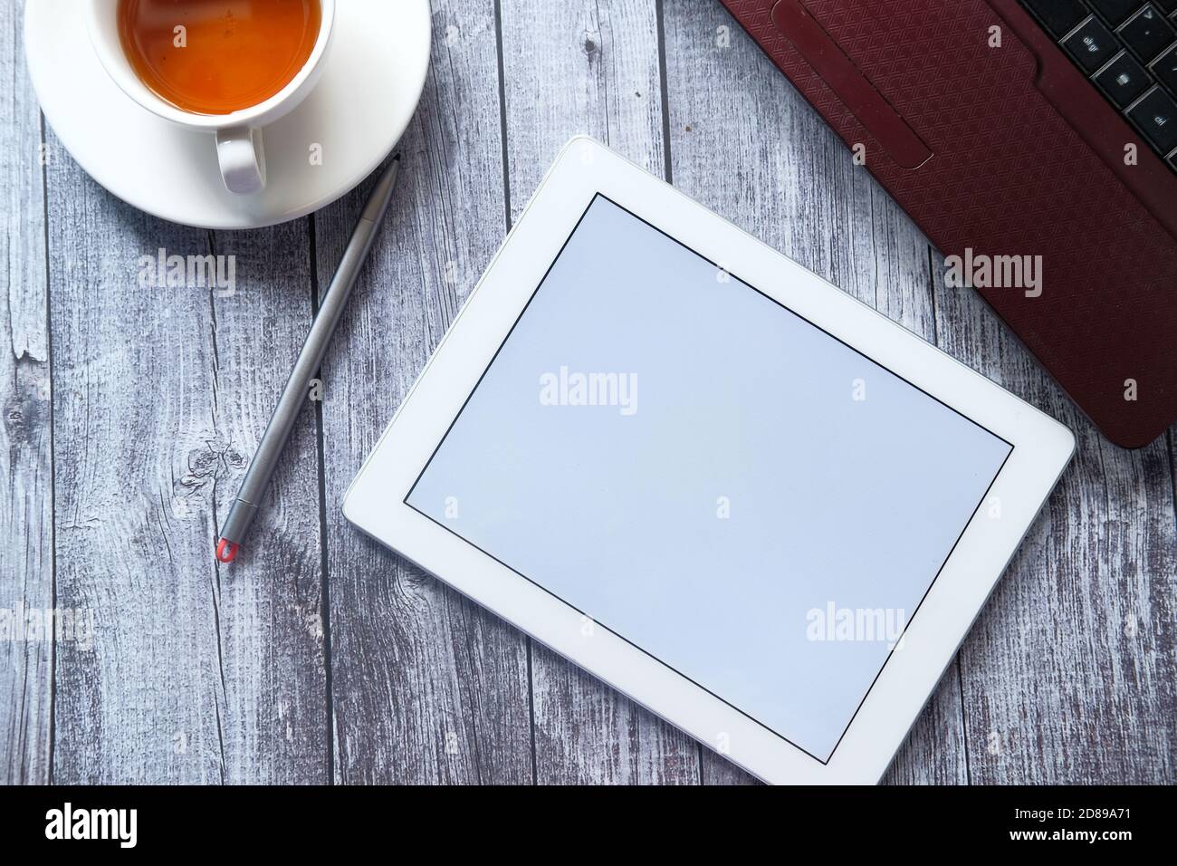 digital tablet and laptop on office desk top view Stock Photo - Alamy