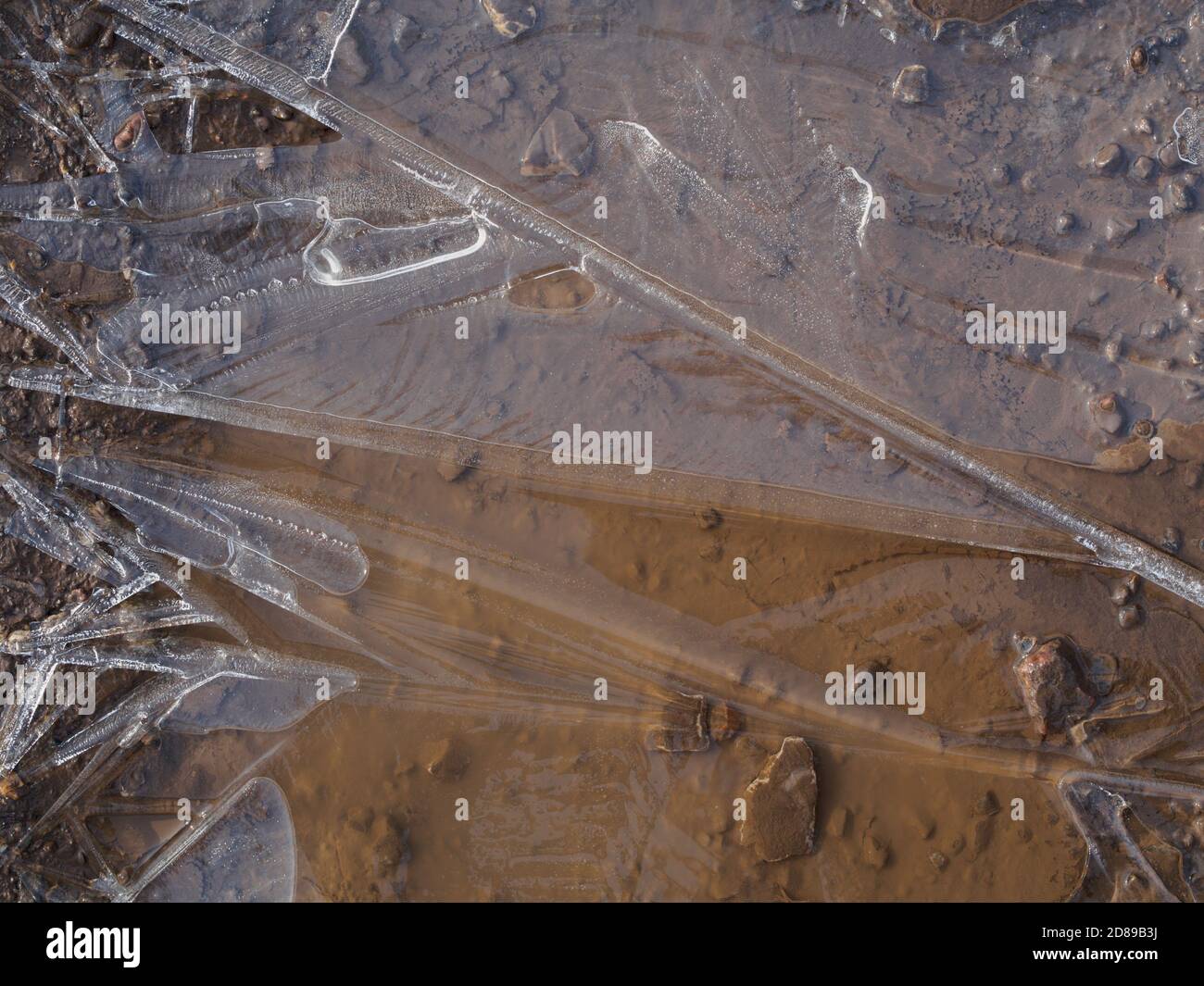 Frozen puddle ice background Stock Photo - Alamy