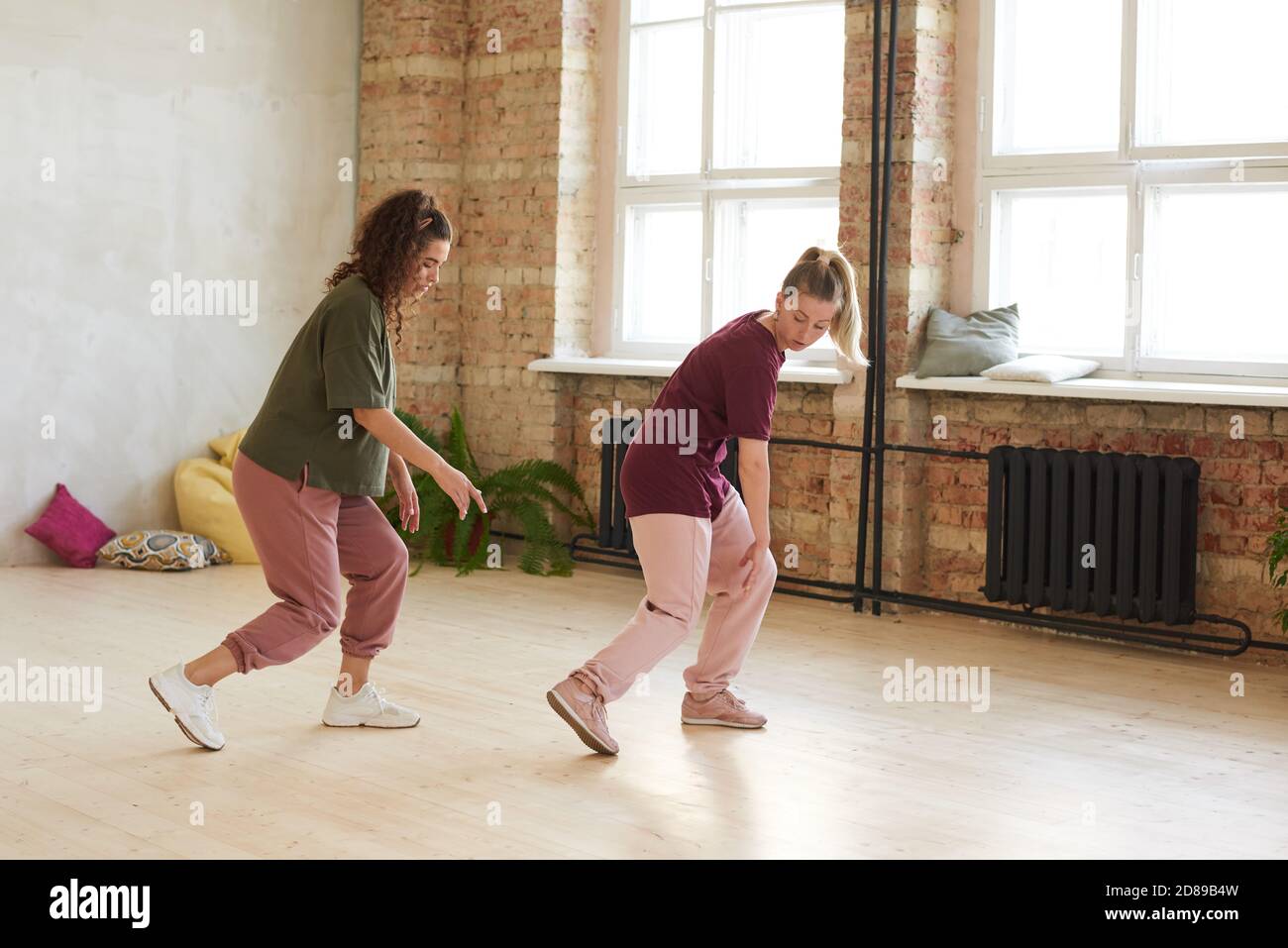 Two young women dancing together they learning new dance in dance ...
