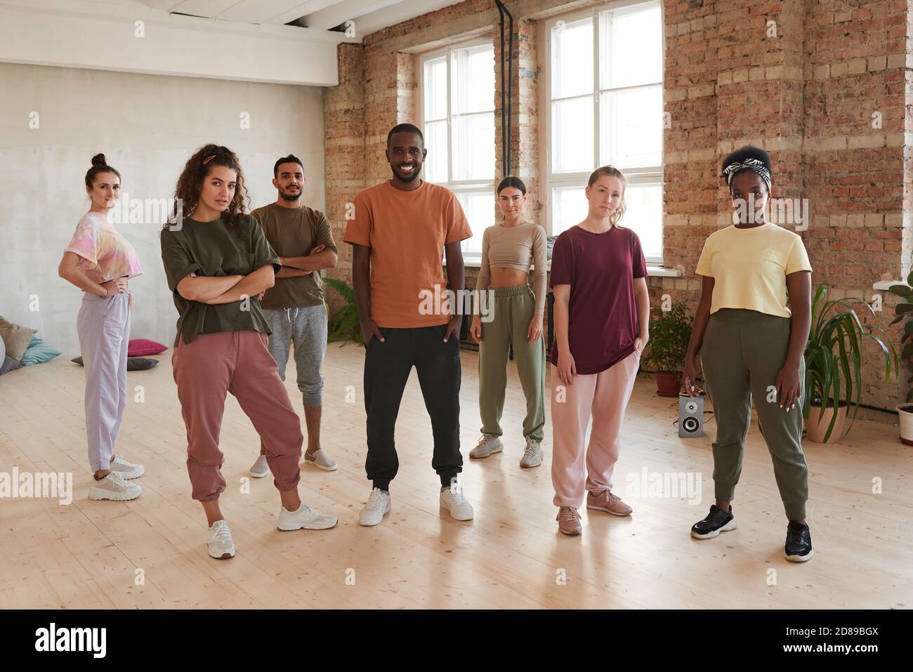 Portrait of young people looking at camera while standing in dance ...