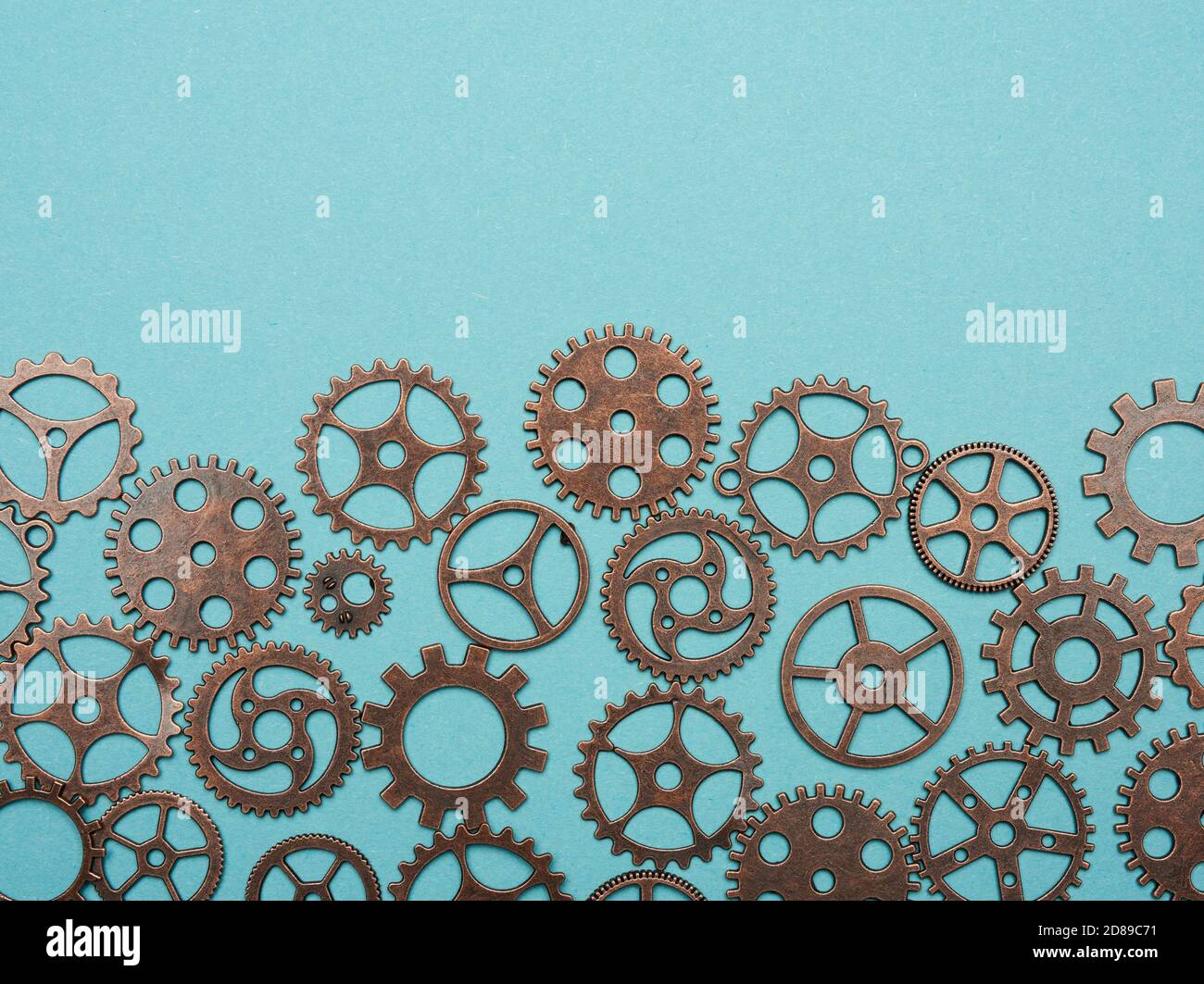copper various cogs on a blue background, copy space Stock Photo - Alamy