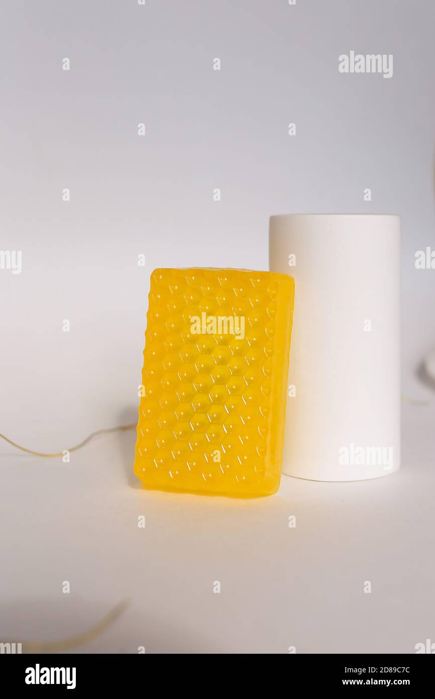 Relief solid yellow soap in light background Stock Photo - Alamy