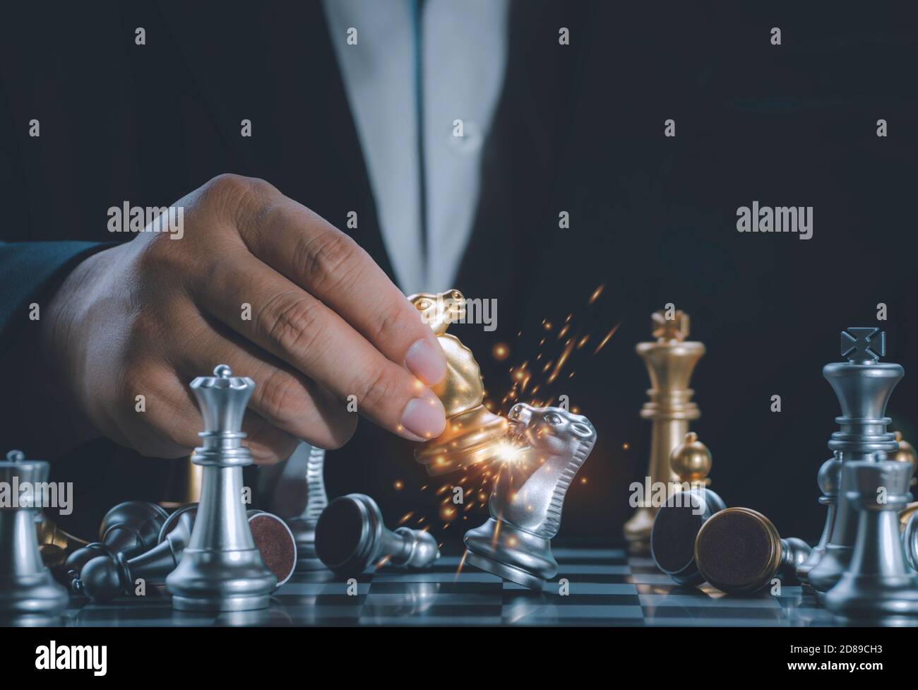 Hand businessman moving the golden knight chess fighting silver knight ...