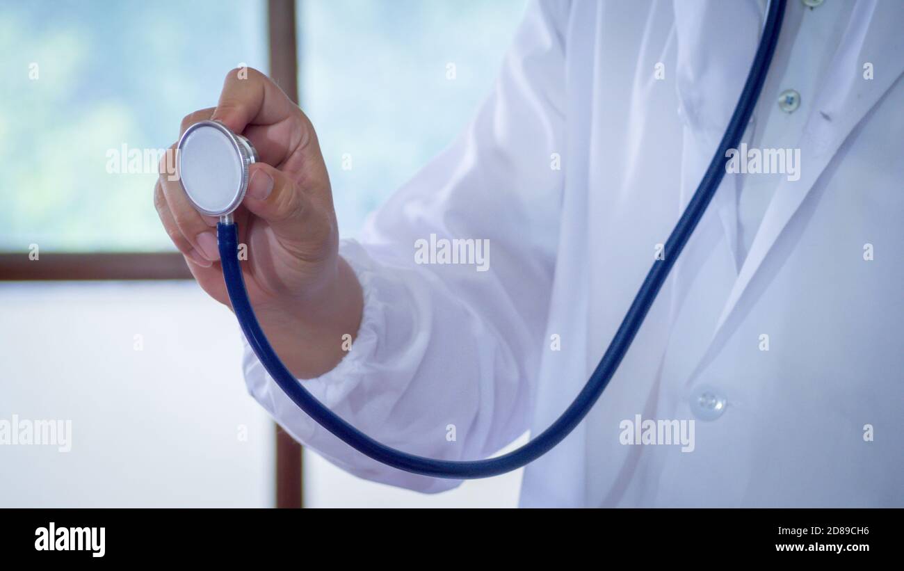 Male medicine doctor hand holding stethoscope against of chest on ...