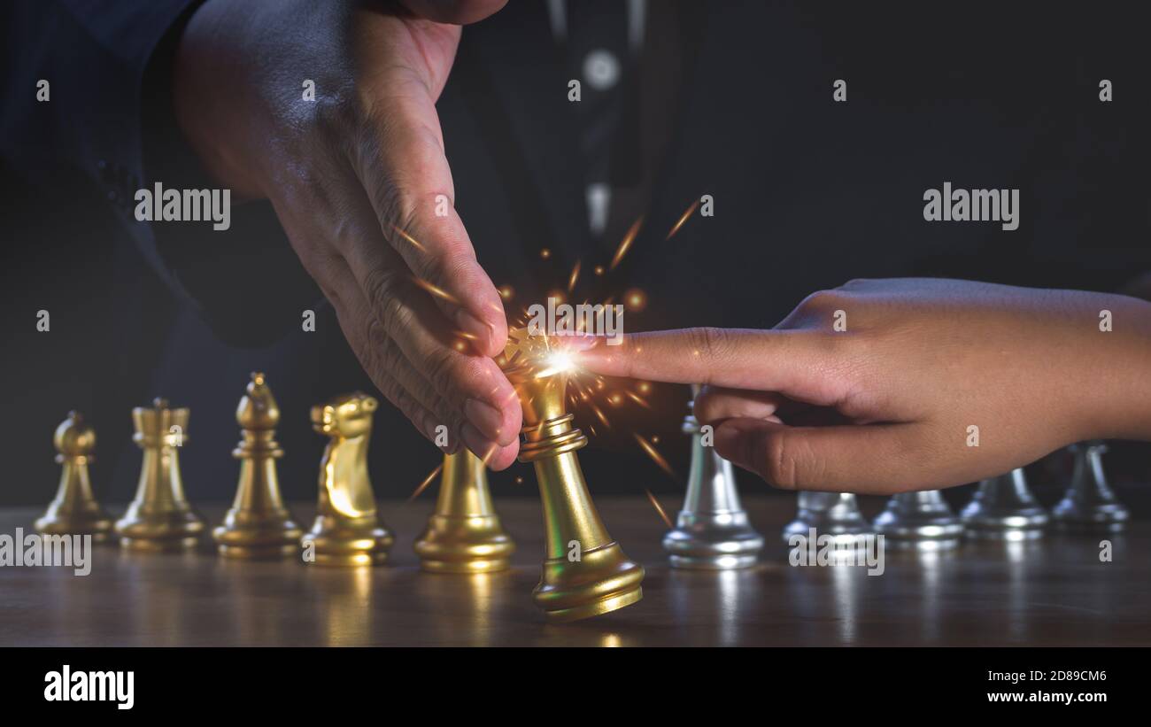 Hand of businessman keeps gold king chess from falling over the attack ...