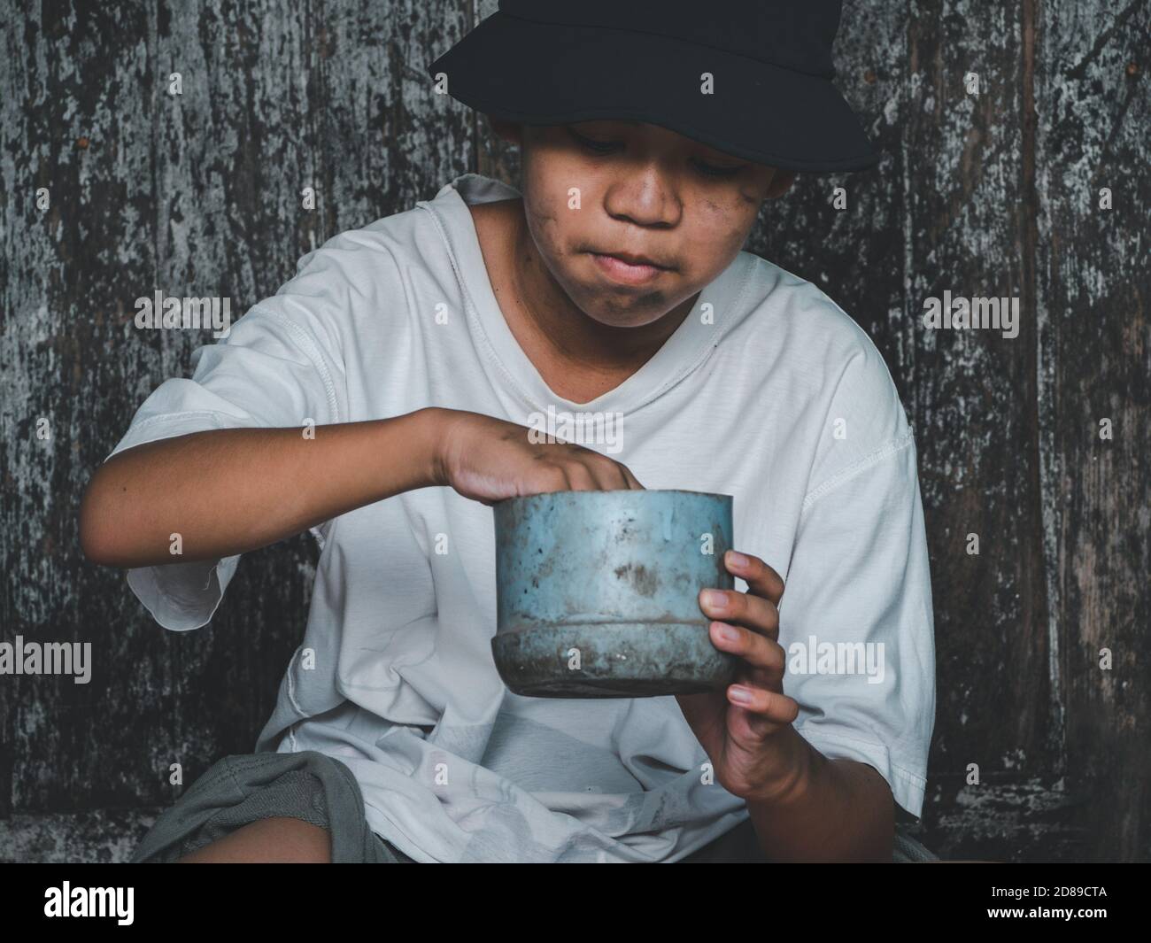 Child or poor homeless holding plastic bowl with hungry and asking help ...