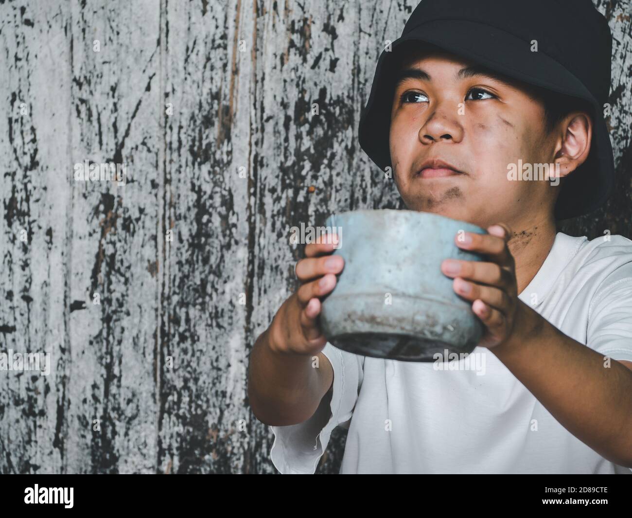 Child or poor homeless holding plastic bowl with hungry and asking help ...
