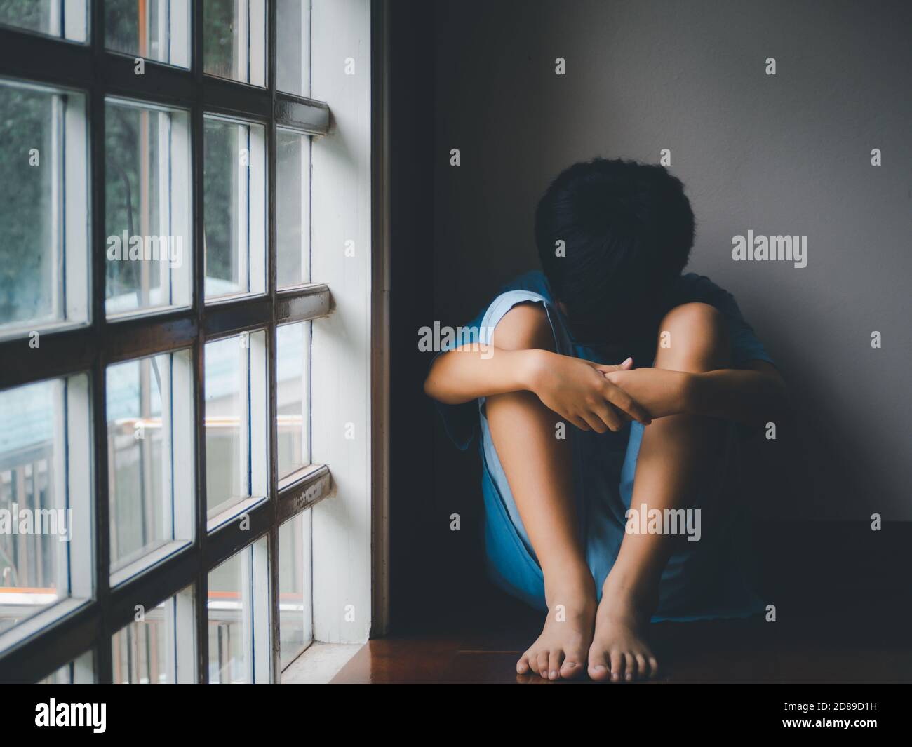 Neglected Lonely Child Leaning At Room corner with sadness and unhappy ...