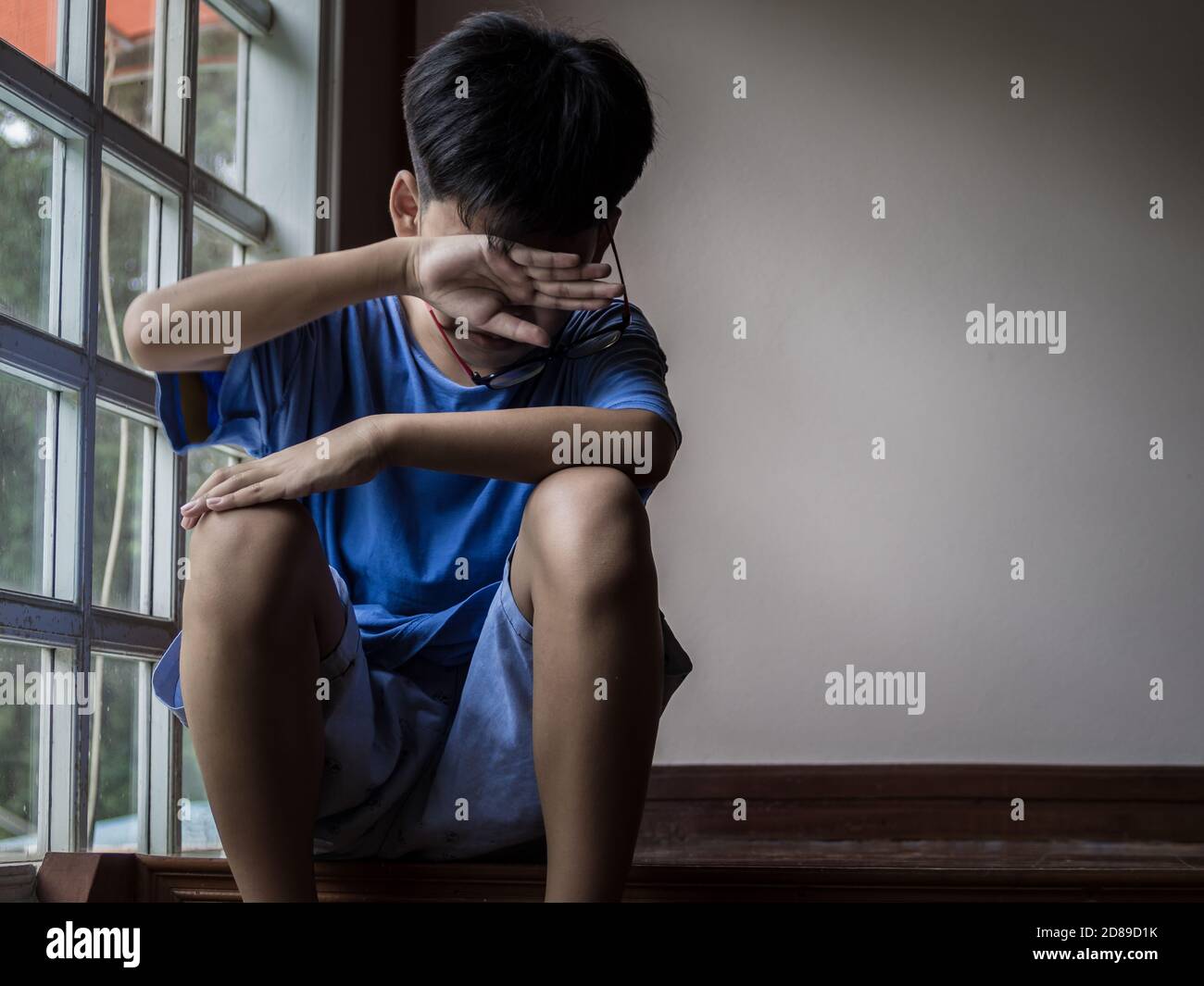 Neglected lonely child crying at room corner with sadness and unhappy ...