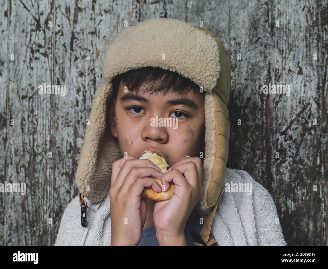 Hungry child eating bread that asking help for food donation from the ...