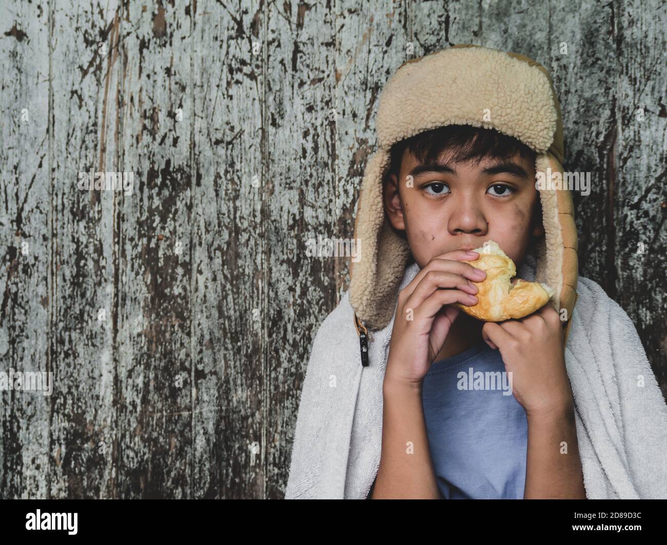 Hungry child eating bread that asking help for food donation from the ...