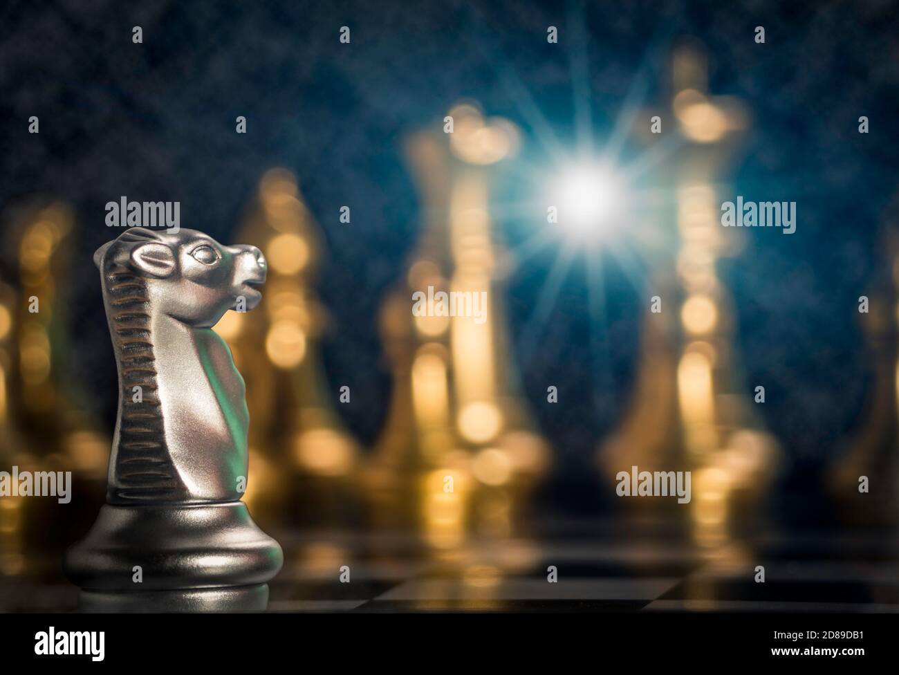Silver knight chess pieces facing in front gold chess on board with ...