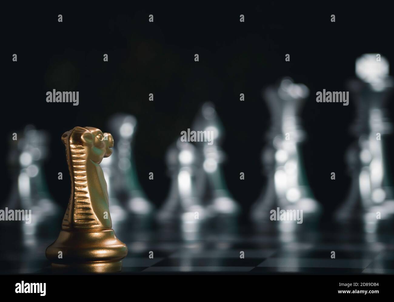 Golden knight chess pieces facing in front silver chess on board with ...