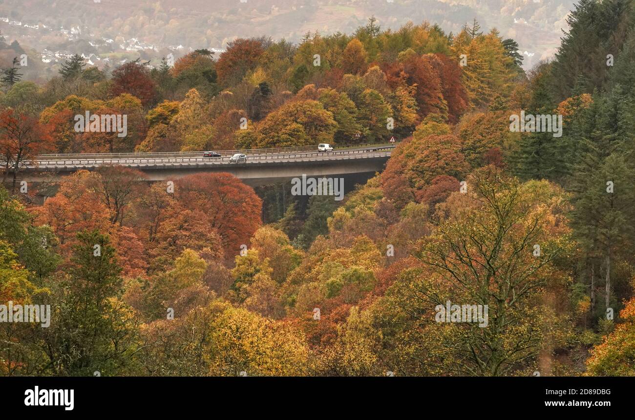 Traffic cutting through the heart of the Lake District, surrounded by ...