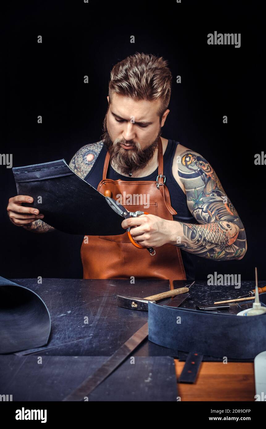 Currier of leather producing leather workpiece in workplace Stock Photo ...