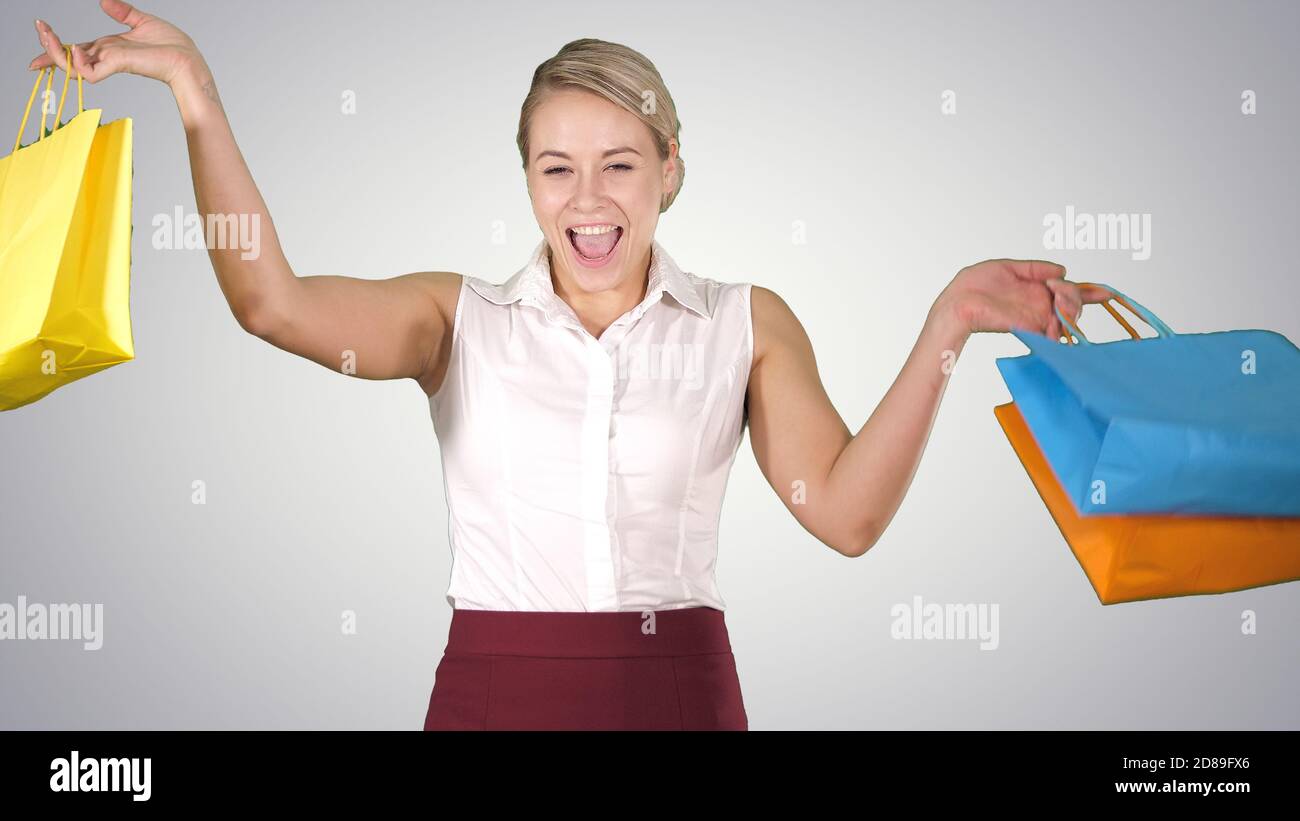 Image of a lovely shopping lady holding her purchases on gradien Stock ...