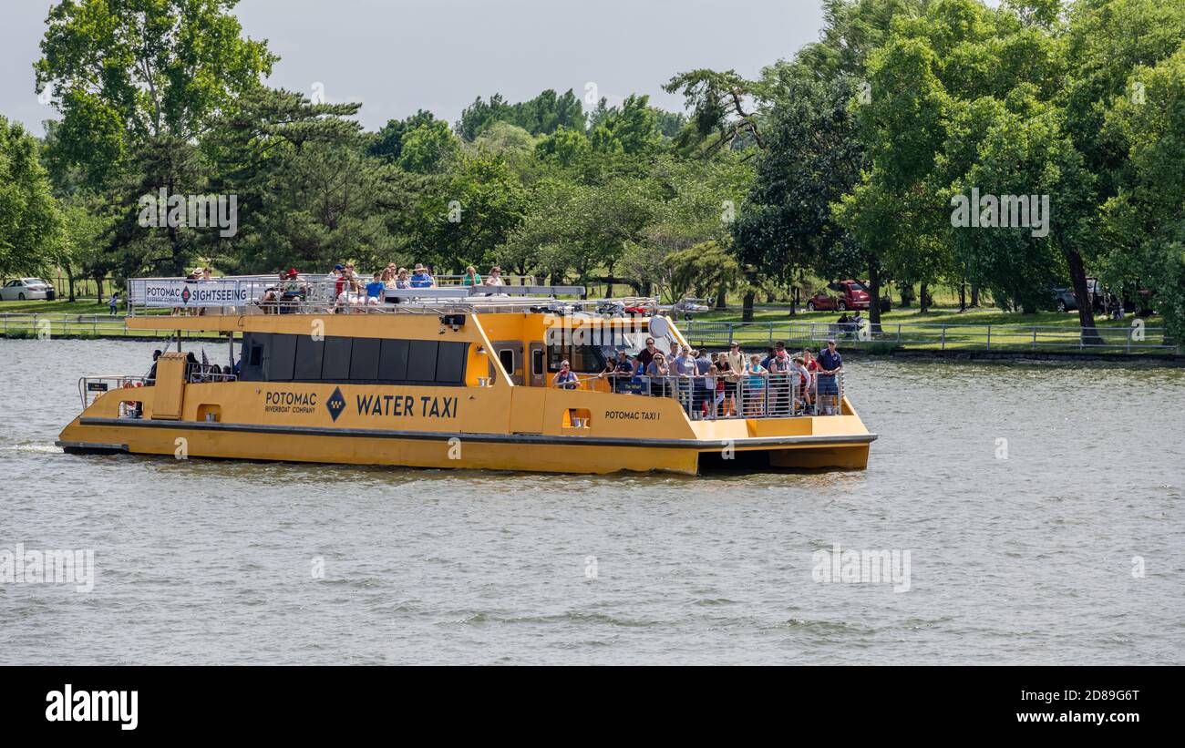Tourists enjoying the early June sunshine crowd the bow of a Potomac ...